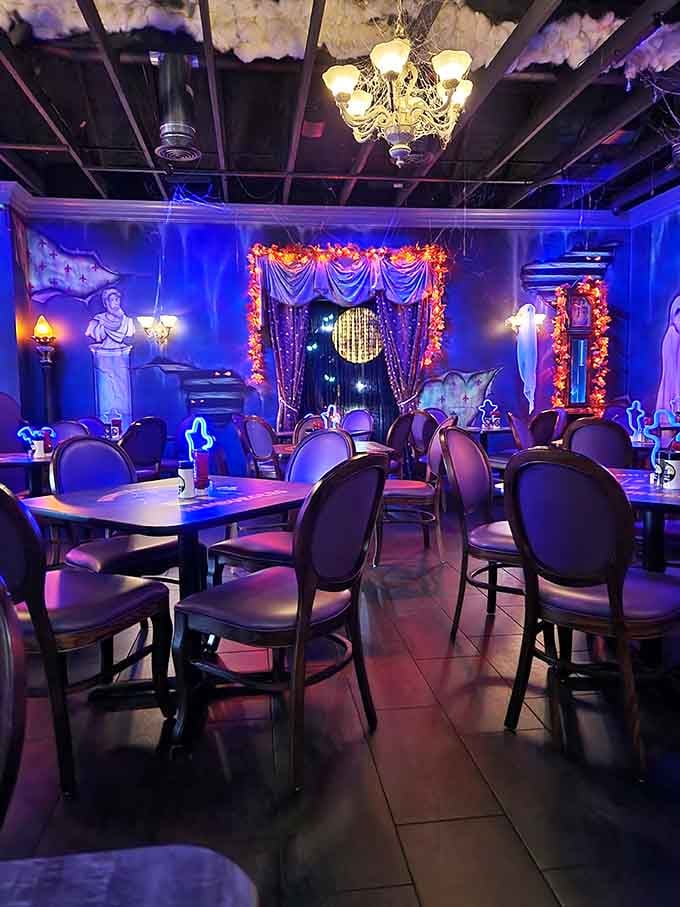 Step into a dining room where elegant chandeliers meet eerie blue lighting in the most delightfully unexpected combination.