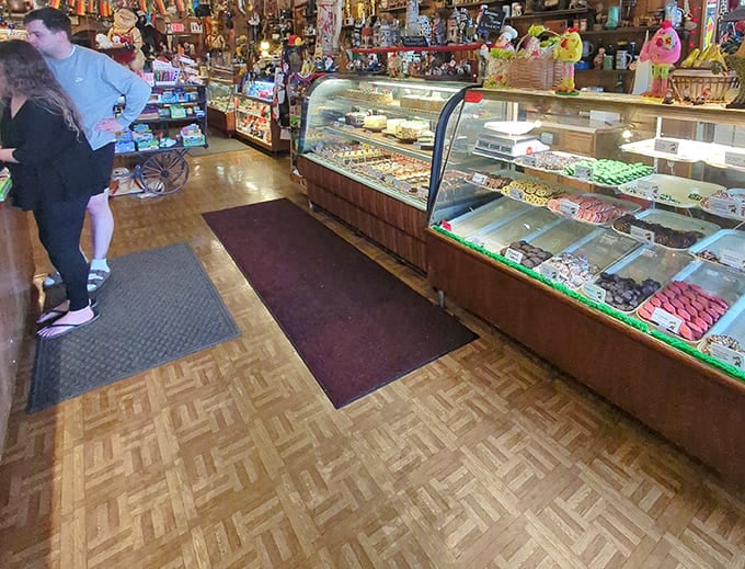 The bakery case gleams with European treasures while gnomes watch from above, judging your pastry choices accordingly.