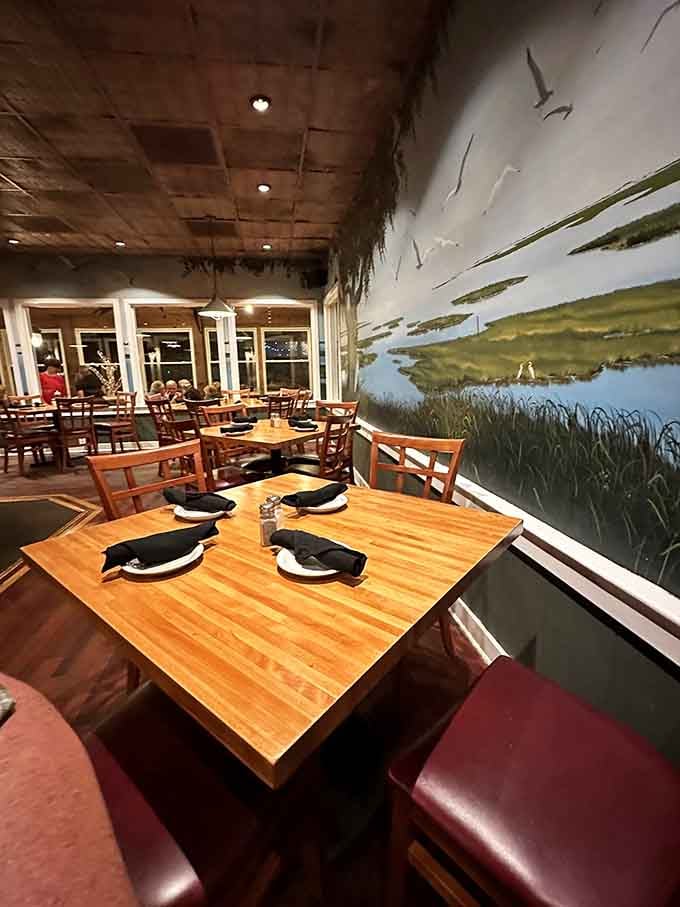 Those marsh murals bring the Lowcountry indoors, making every seat feel like waterfront dining without the seagulls stealing your fries.