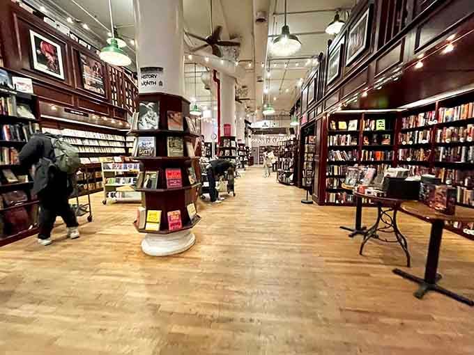 Floor-to-ceiling burgundy shelves stretch endlessly, creating a book lover's version of Willy Wonka's factory.