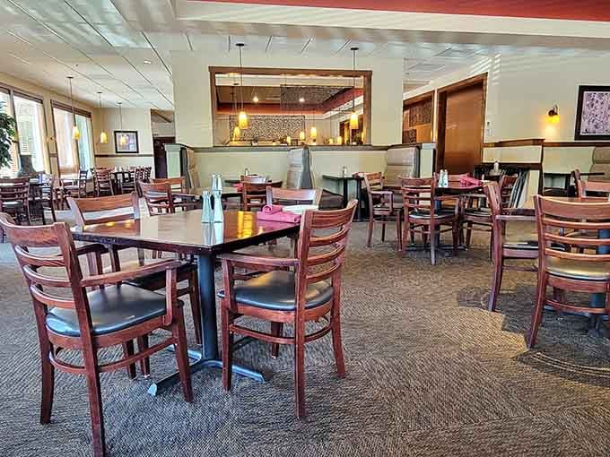 Inside, warm wood tones and thoughtful spacing create that perfect sweet spot between "fancy night out" and "comfortable enough to actually enjoy your meal."