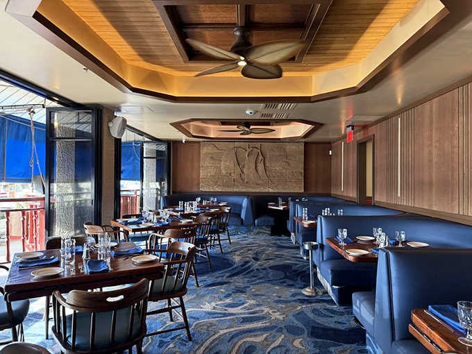 Elegant wooden ceiling fans and blue wave-patterned carpeting create a nautical atmosphere that whispers "you're on island time now."