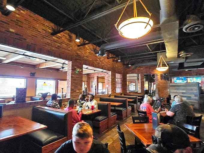 Exposed brick walls, pendant lighting, and comfortable booths create the perfect backdrop for the serious business of enjoying great food.