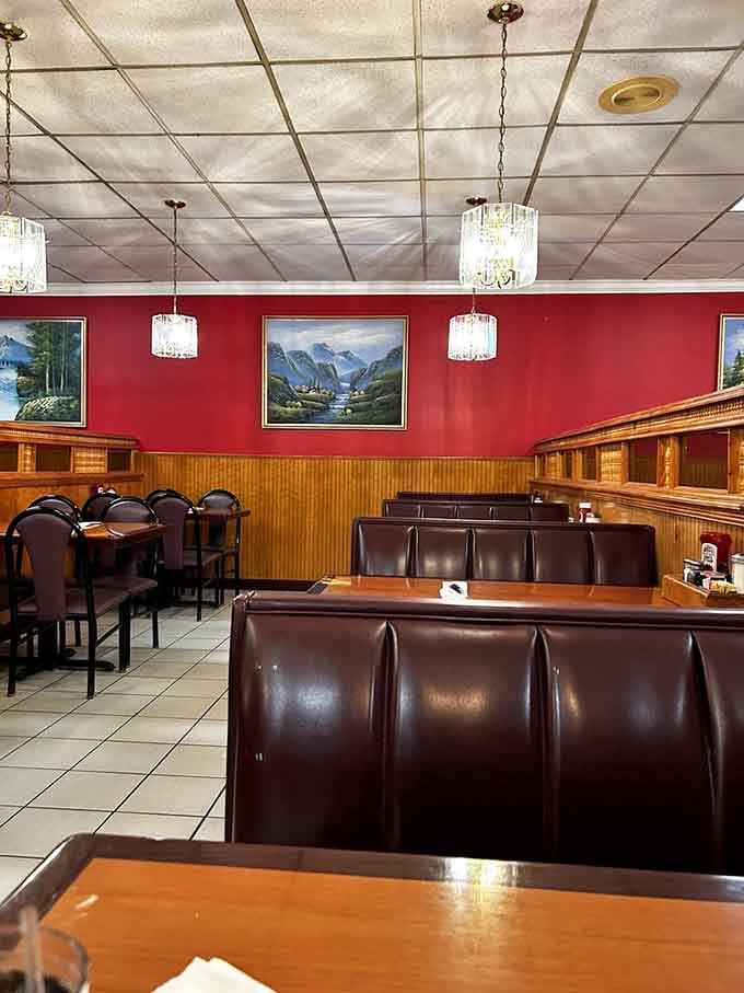 Classic diner aesthetics with red walls and brown booths&mdash;where comfort meets nostalgia in a setting that whispers, "Stay awhile."
