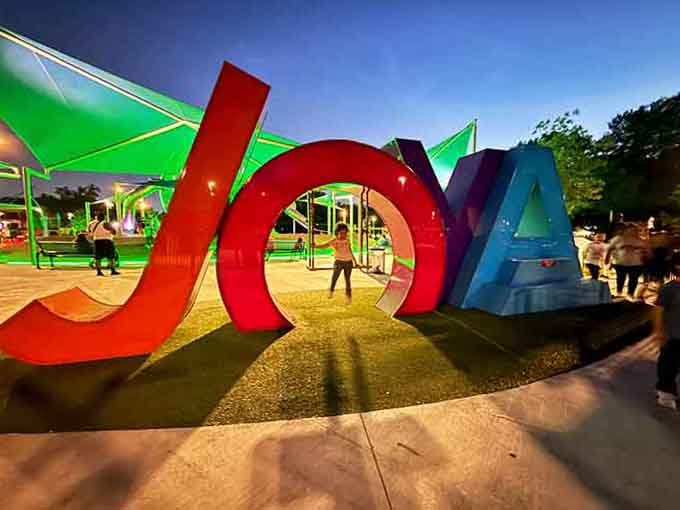 The colorful JOYA sign lights up like a beacon, calling families to come discover their new favorite spot.