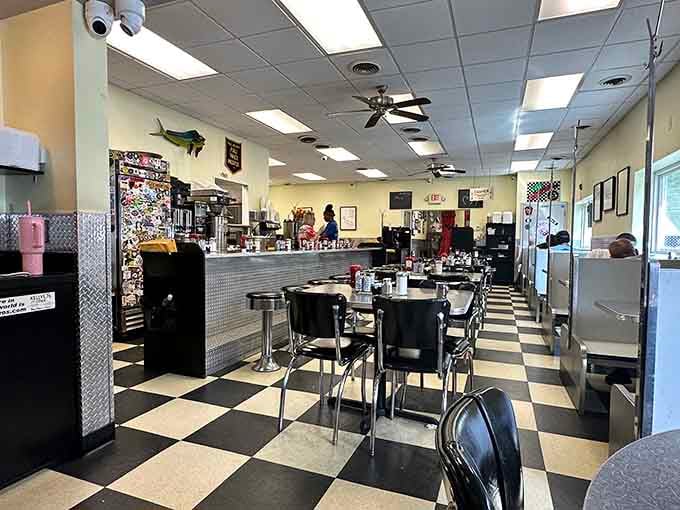 Black and white checkered floors meet chrome stools in a time machine that runs on coffee and nostalgia.