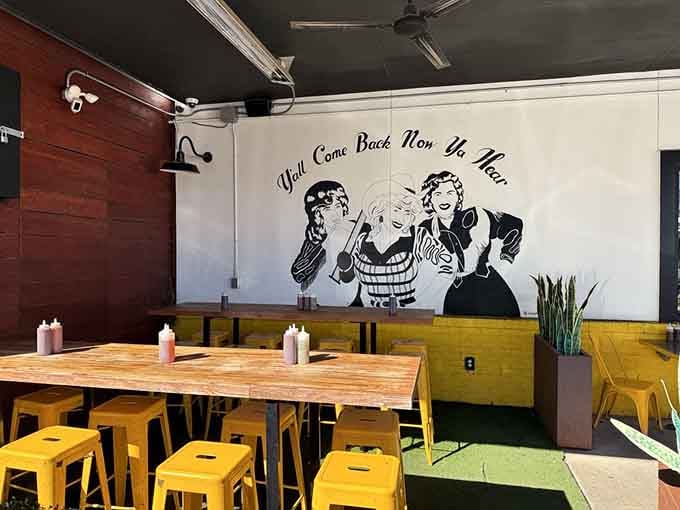 The vintage wall art and sunny yellow seating create a vibe that's equal parts nostalgic diner and modern Austin cool.