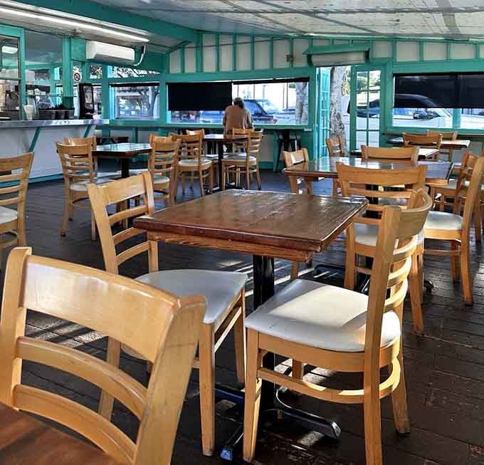 Simple wooden tables and chairs prove that great food needs no fancy staging, just hungry people.