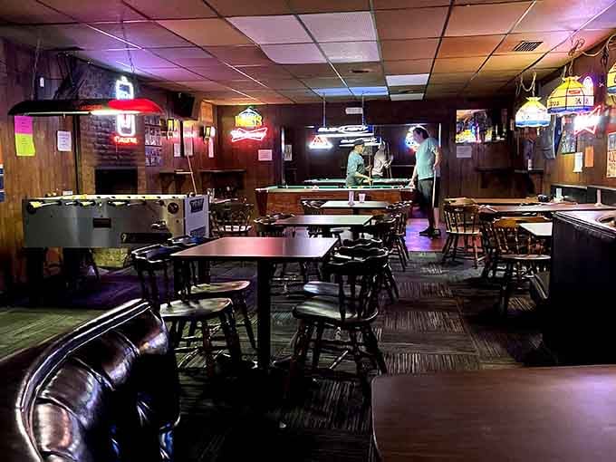 Wood paneling, pool tables, and neon signs create the perfect trifecta of dive bar authenticity and charm.