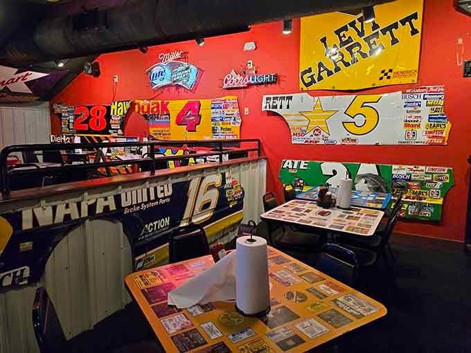 Racing memorabilia covers every surface like a NASCAR fan's fever dream, and honestly, it's absolutely glorious.