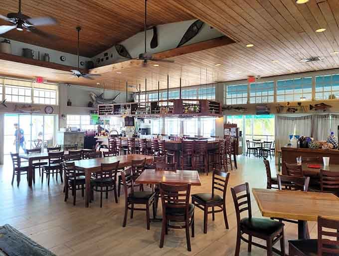 Natural wood tones and floor-to-ceiling windows create a dining room where the ocean views steal the show effortlessly.
