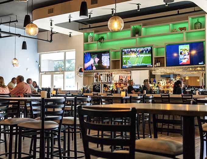 Modern comfort meets neighborhood charm in this bright, inviting dining space with plenty of screens.