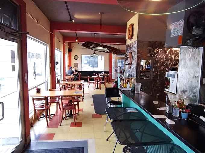 Colorful floors, cozy tables, and that turquoise counter create the perfect backdrop for breakfast adventures ahead.