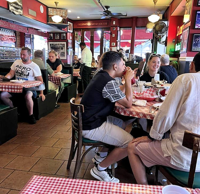 Red walls, checkered tablecloths, and happy faces &ndash; this is what a proper pizzeria looks like, folks.