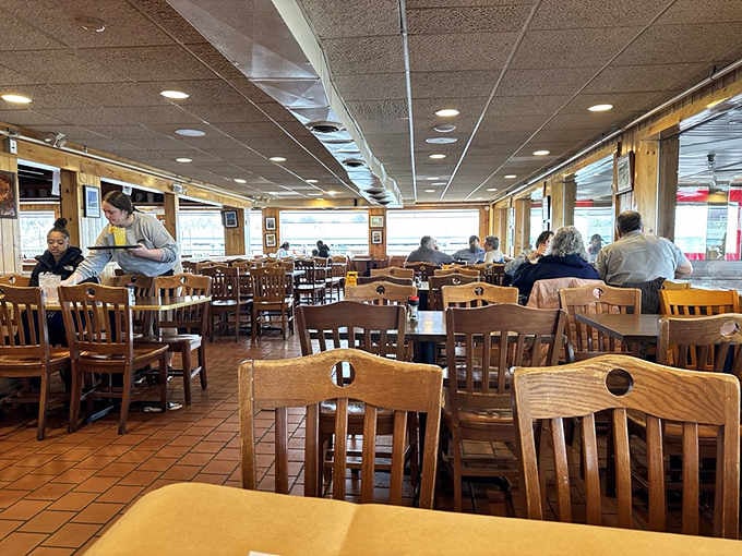 Classic crab house vibes with wooden chairs and windows framing water views that never get old.