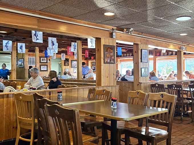 Wood paneling and nautical flags overhead create that classic Chesapeake vibe where formality goes to die and flavor comes to thrive.