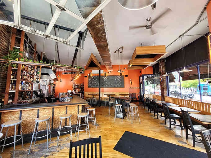 Orange walls and exposed brick create a space that's equal parts laboratory and living room, somehow perfectly.