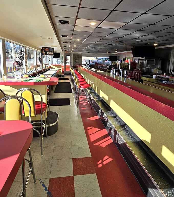 Red vinyl, chrome trim, and counter stools lined up like a perfectly choreographed chorus line of comfort.