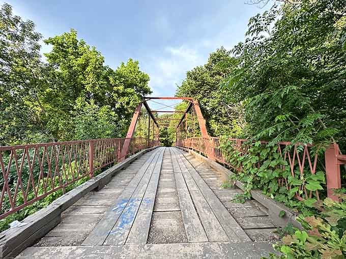 The wooden planks stretch ahead like a runway to another world, weathered but still standing strong after decades.