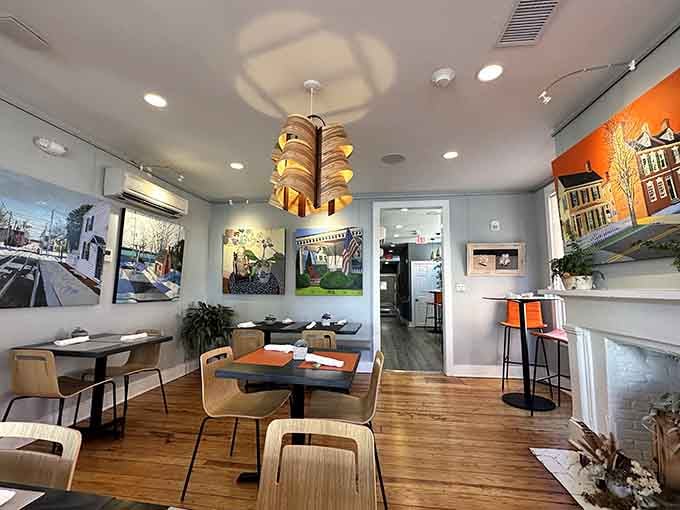 Contemporary meets cozy in this thoughtfully designed space where local art and warm lighting create the perfect dining atmosphere.