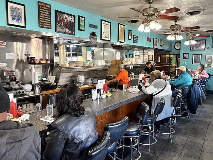 Counter seating where the real magic happens, watching your breakfast come to life on the griddle before your eyes.