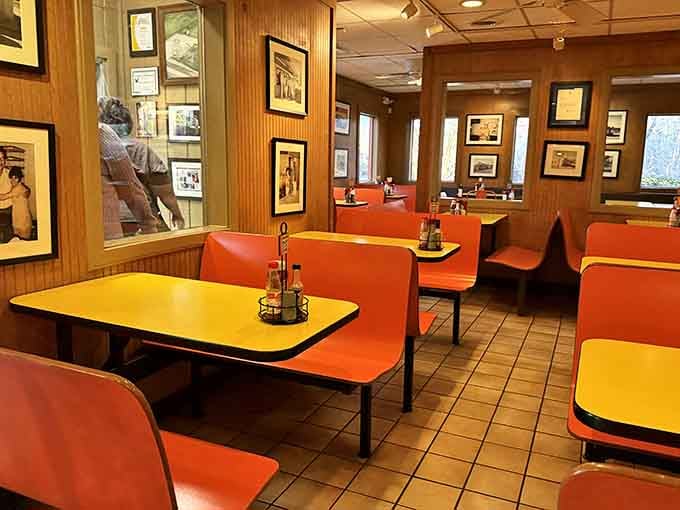 Those bright orange booths and yellow tables create the kind of cheerful atmosphere that makes every meal feel like a celebration.
