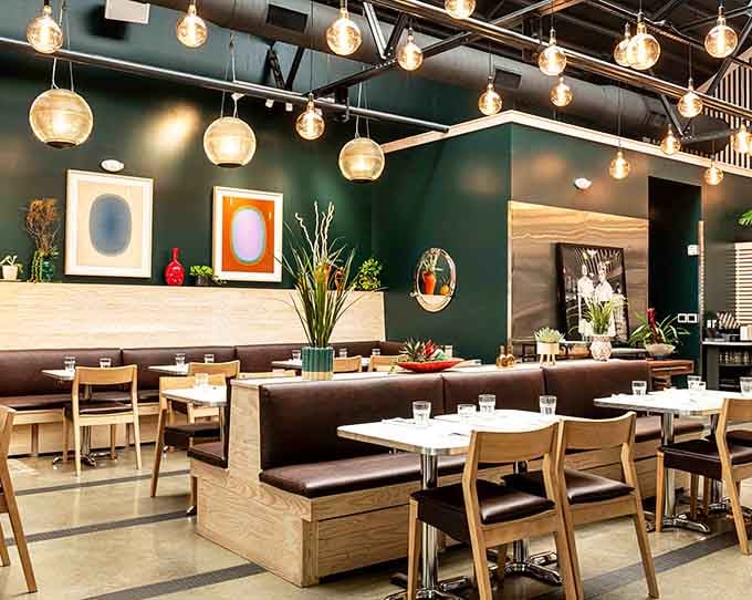 Modern comfort meets retro charm in a space where Edison bulbs illuminate your culinary dreams perfectly.