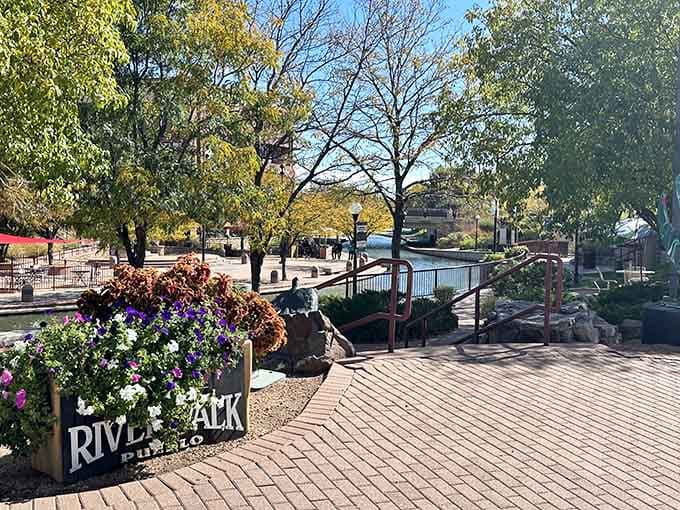 The Riverwalk Plaza welcomes visitors with colorful blooms and pathways that promise adventure around every corner.