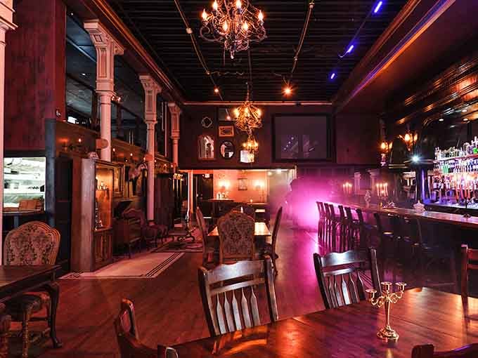 Victorian elegance meets moody lighting in a space where every chair has witnessed countless dramatic conversations.