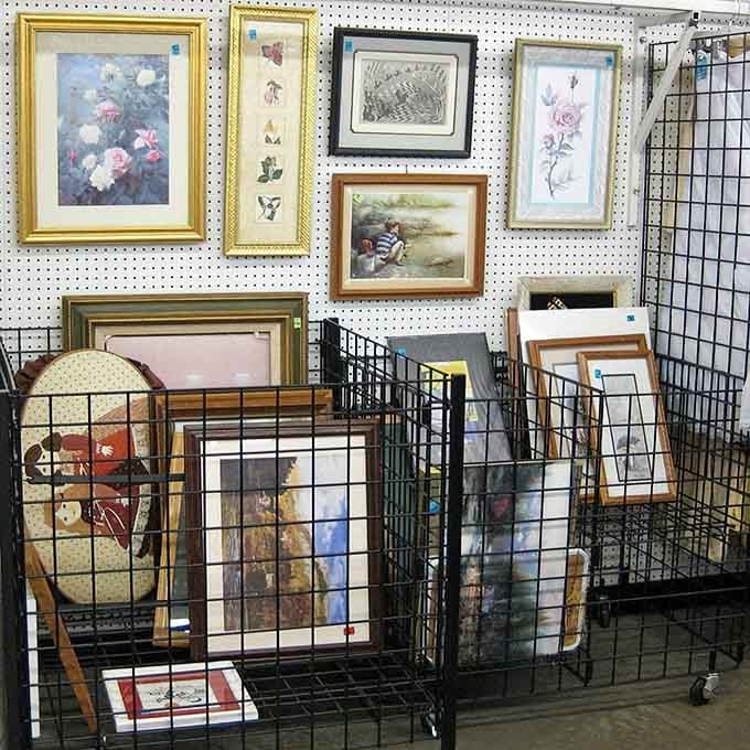 Framed florals and pastoral scenes await their next living room, each telling stories from someone's past.