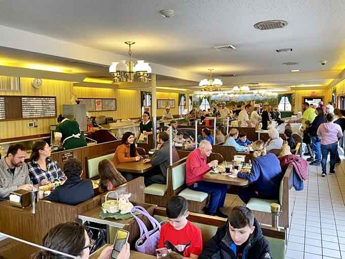 Yellow walls and packed booths create the kind of bustling energy that makes waiting for a table feel worthwhile.