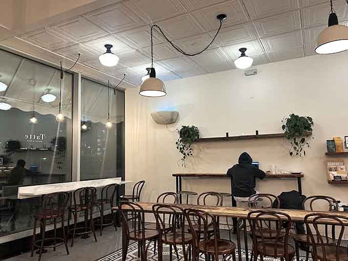 Pressed tin ceilings and bentwood chairs create that old-world coffeehouse vibe where laptops and lattes coexist peacefully.