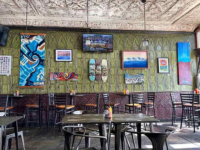 Pressed tin ceilings and local art create an atmosphere where every meal feels like a celebration of Colorado.