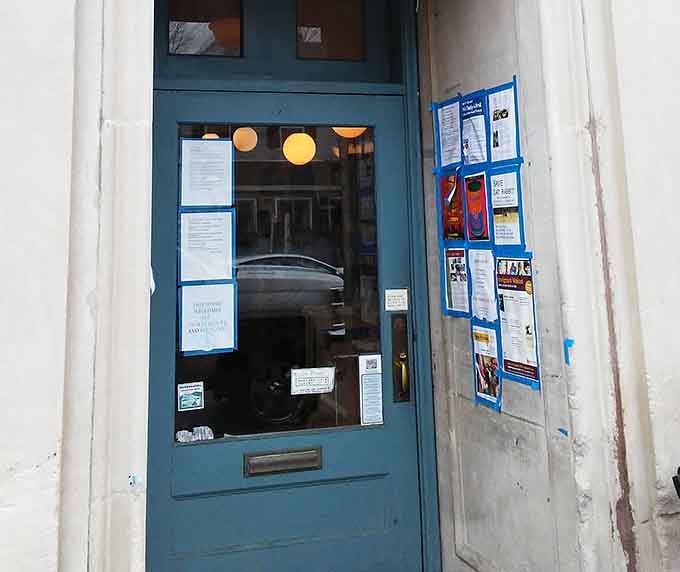 The welcoming blue door opens to possibilities: new stories to discover and wine to savor while you browse.