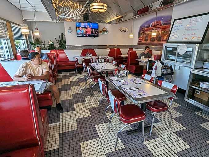Red vinyl booths and checkerboard floors create the kind of atmosphere where time slows down deliciously.