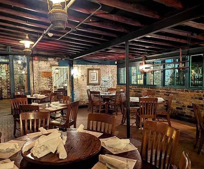 Exposed brick and dark wood beams create an atmosphere where you half expect a sea captain to walk in any moment.