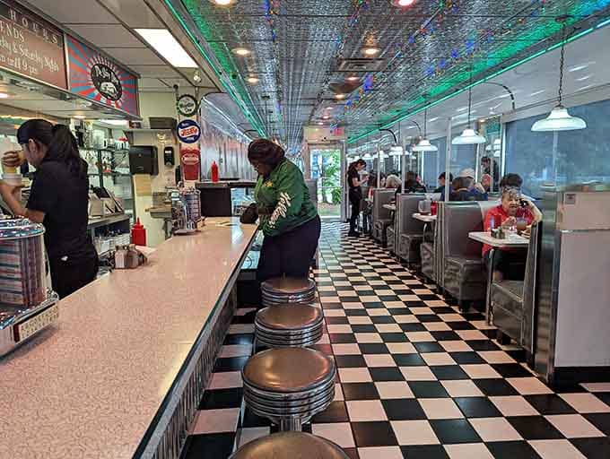 Black and white floors, vinyl stools, and chrome everywhere: this is what happiness looks like.