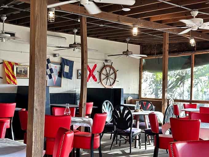 Nautical flags and ship wheels create an atmosphere that's part fishing vessel, part dining room, all coastal Carolina charm.