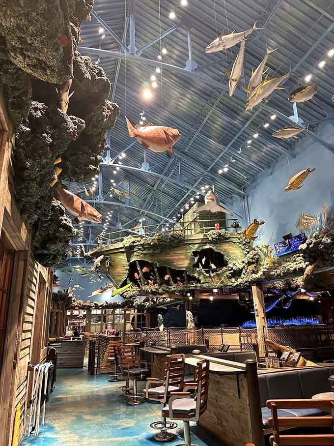 A shipwreck centerpiece surrounded by dining tables proves that nautical disasters make surprisingly excellent dinner conversation starters.