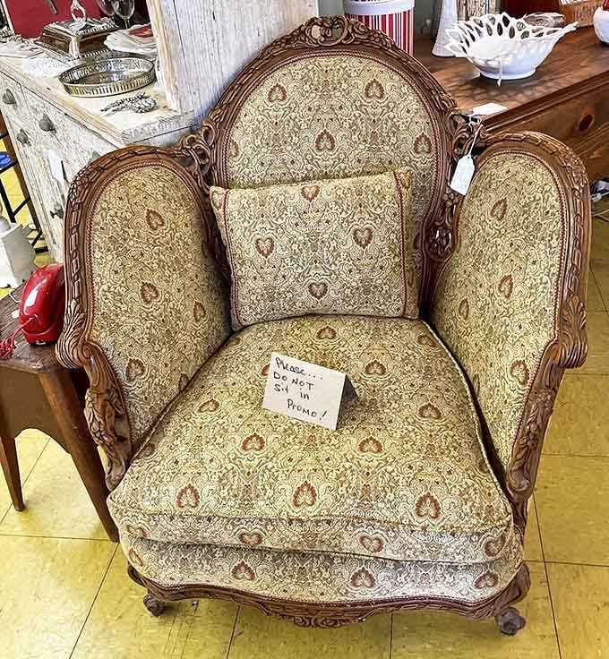 "Please do not sit" reads the sign, but this ornate vintage armchair has clearly hosted decades of conversations and contemplations.