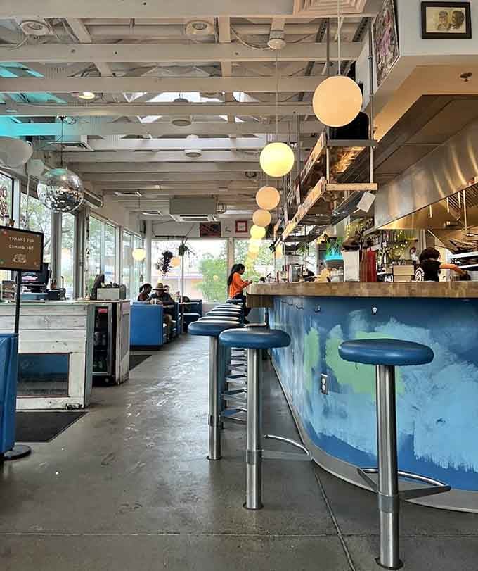 Chrome stools and blue counters create a retro paradise where breakfast dreams become delicious reality.