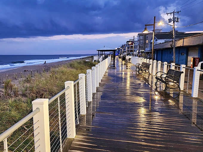 Dusk transforms the boardwalk into a magical promenade where raindrops create mirror-like reflections, proving that even on cloudy days, Salisbury Beach delivers atmospheric charm.