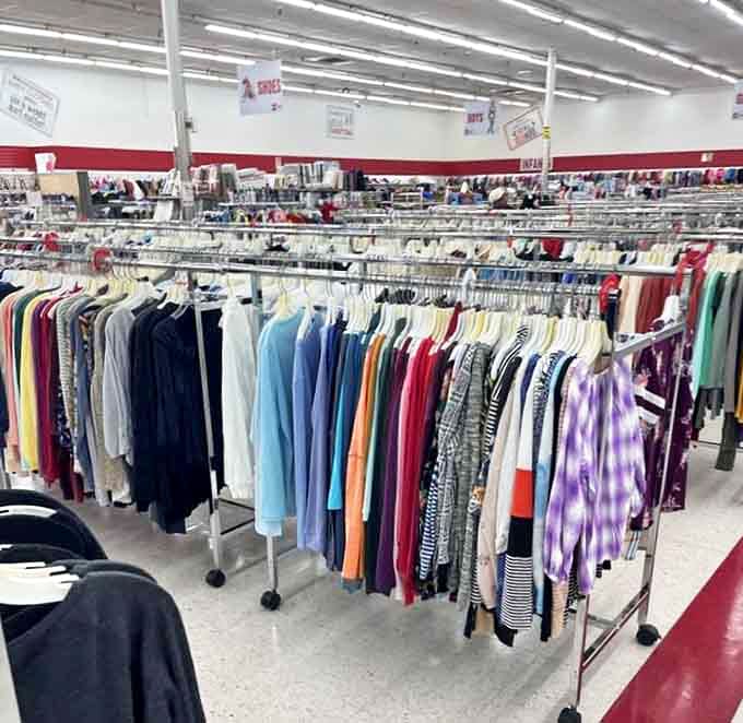A rainbow of possibilities hangs in perfect formation, each garment whispering "take me home" to passing shoppers.