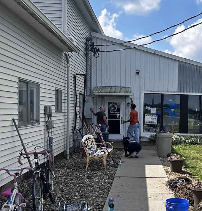 The side entrance offers a glimpse into the thrifter's journey&mdash;complete with outdoor treasures and the promise of air conditioning inside.