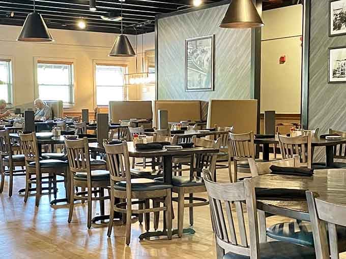 Simple wooden chairs, pendant lighting, and maritime photos create the perfect backdrop for seafood that deserves your full attention.