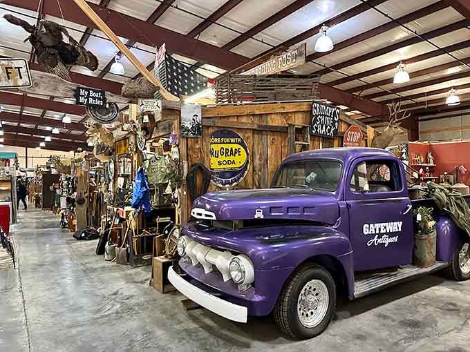 That purple Ford truck isn't just transportation; it's a time machine parked indoors, surrounded by decades of American nostalgia.