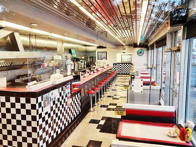 Classic diner perfection: red vinyl stools, checkerboard tiles, and a counter where strangers become friends over shared appreciation of sizzling breakfast platters.