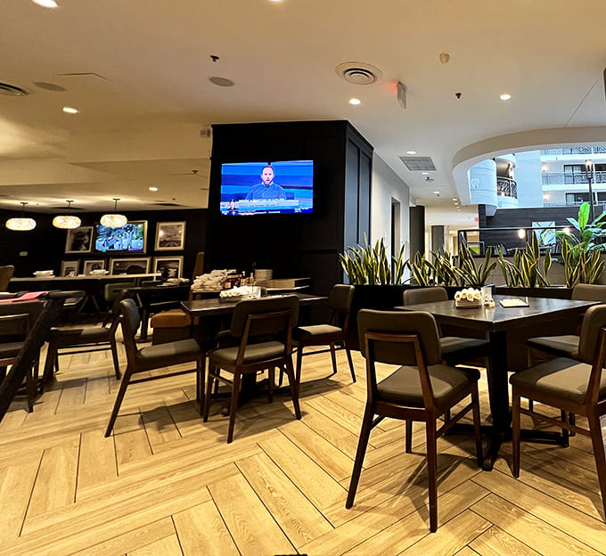 Herringbone floors, comfortable seating, and strategically placed greenery create that perfect "stay awhile" atmosphere that's increasingly rare these days.