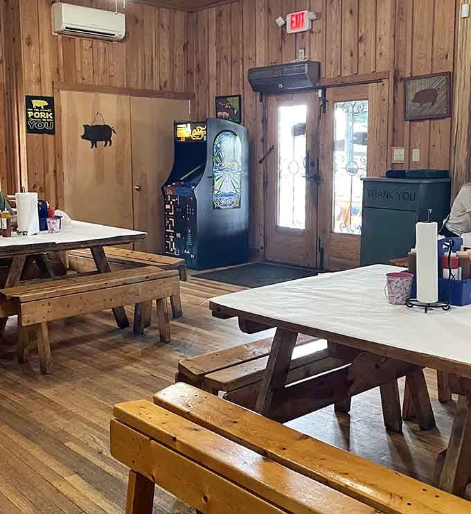 Wooden picnic tables and paneling create that authentic "we're serious about barbecue, not décor" vibe. The vintage arcade game is the cherry on top of this no-nonsense experience.