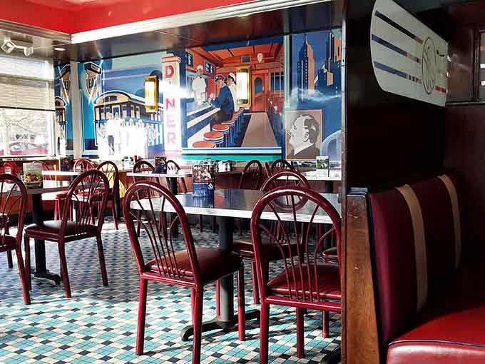 Inside, vintage murals and checkerboard floors create an atmosphere where every meal feels like a special occasion.